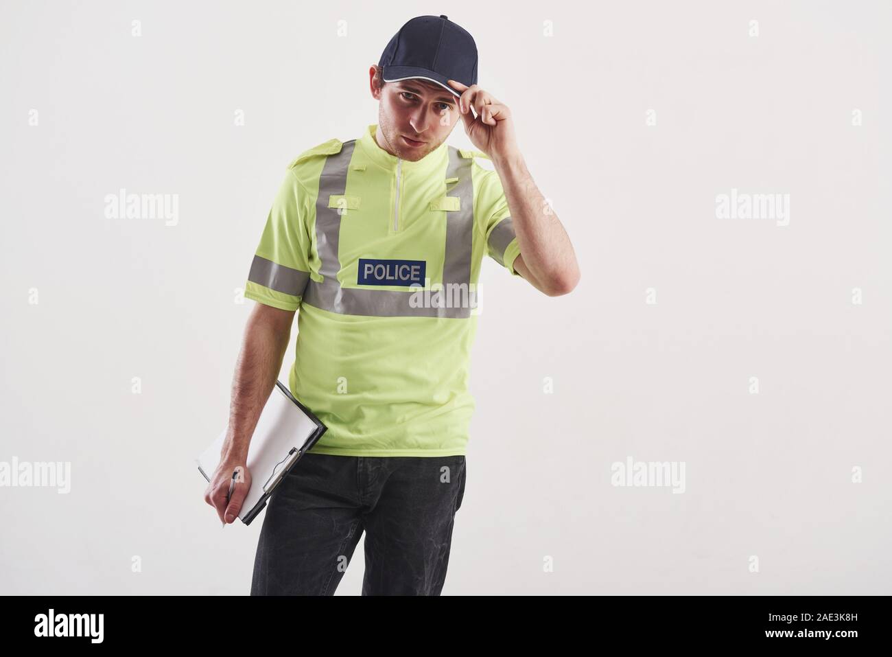 I'll be your helper today. Policeman in green uniform stands against ...