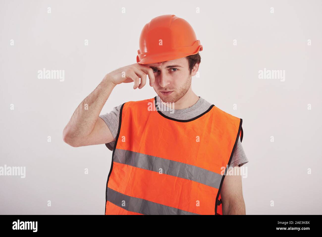 Safety first. Man in orange colored uniform stands against white ...