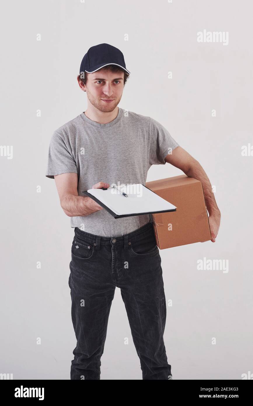 Please take your order. Guy with box in hands stands against white ...