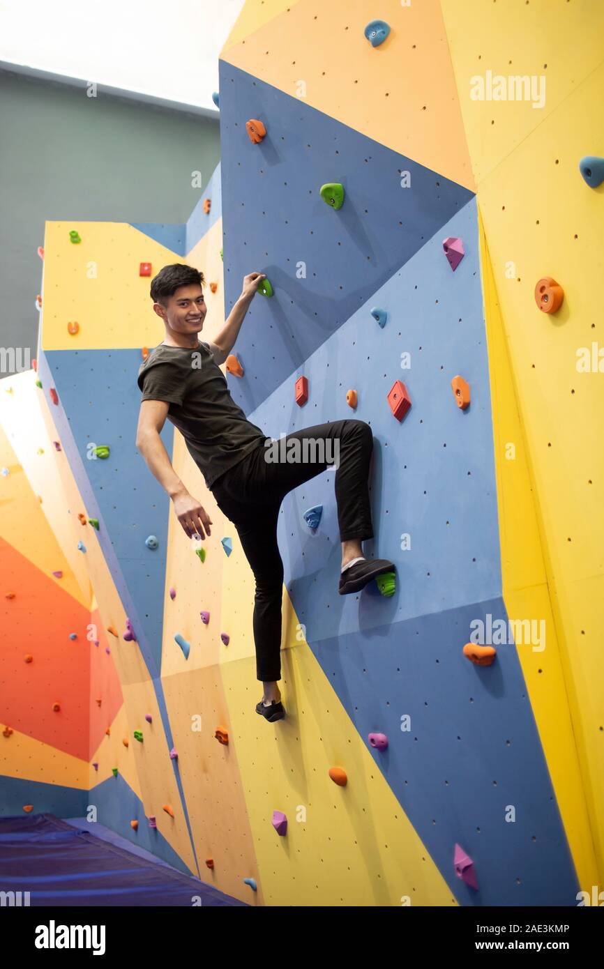 Man climbing over wall hi-res stock photography and images - Alamy
