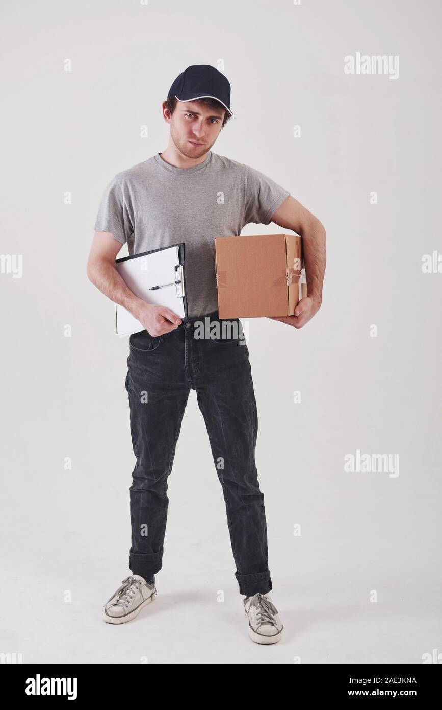 Modern post services. Guy with box in hands stands against white ...