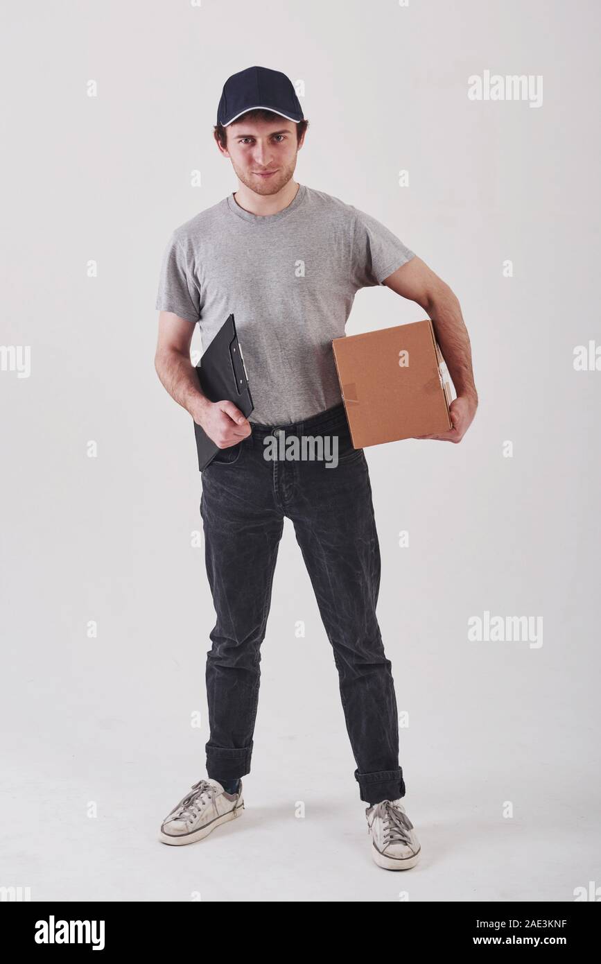 Customer is waiting for me. Guy with box in hands stands against white ...