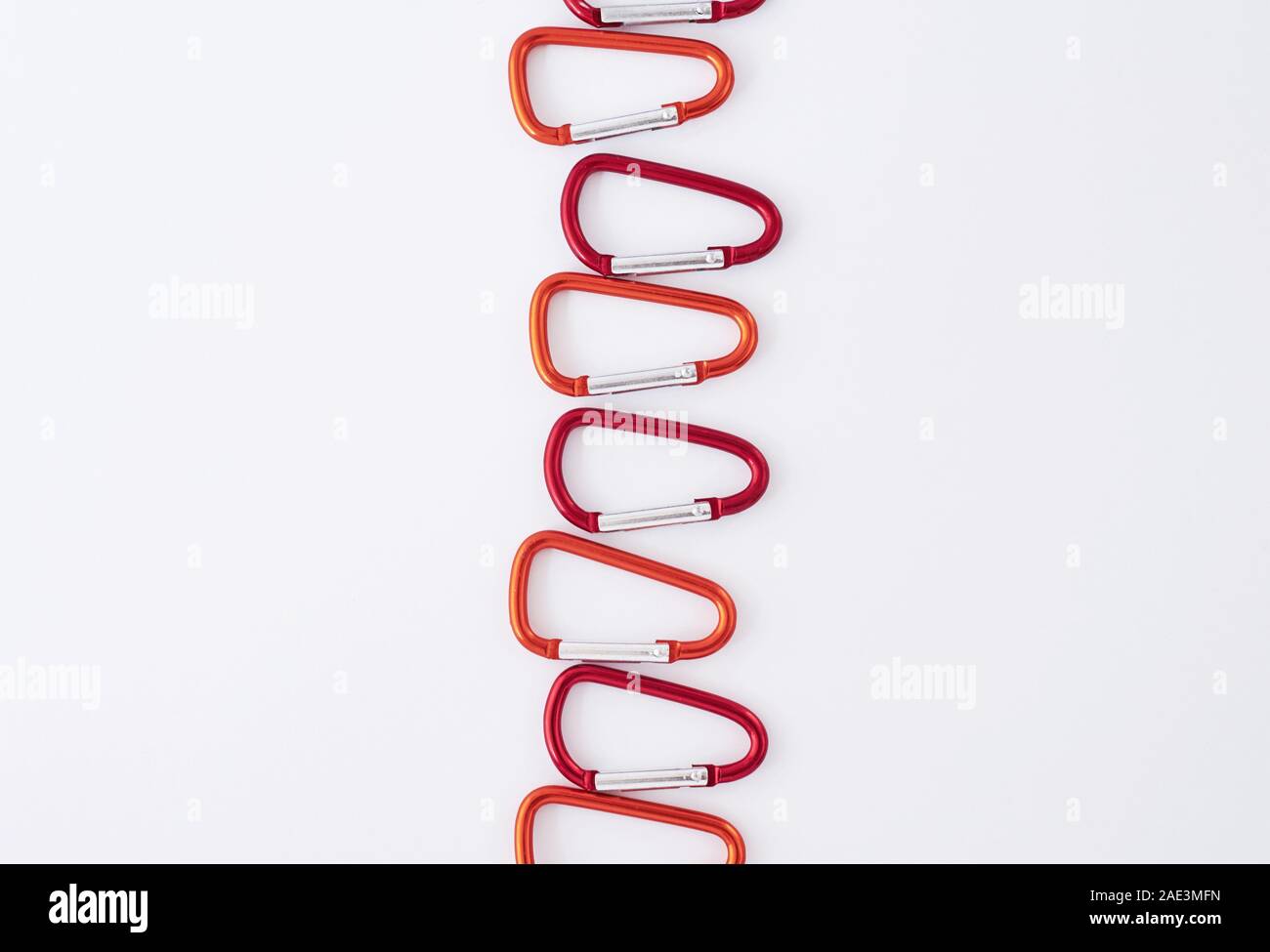 In the center of image. Many of the red colored carabiners on lying on ...