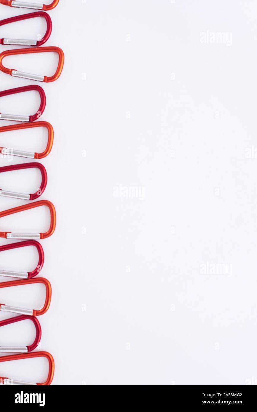 Huge choice. Many of the red colored carabiners on lying on the white ...