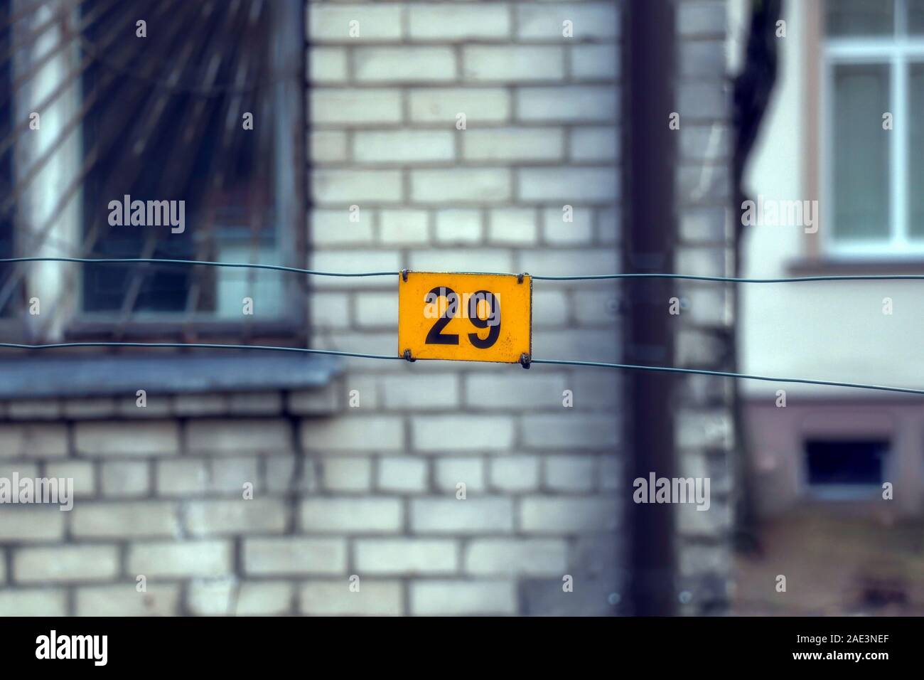 Numberplate with digit twenty nine, 29 on yellow background on the ...