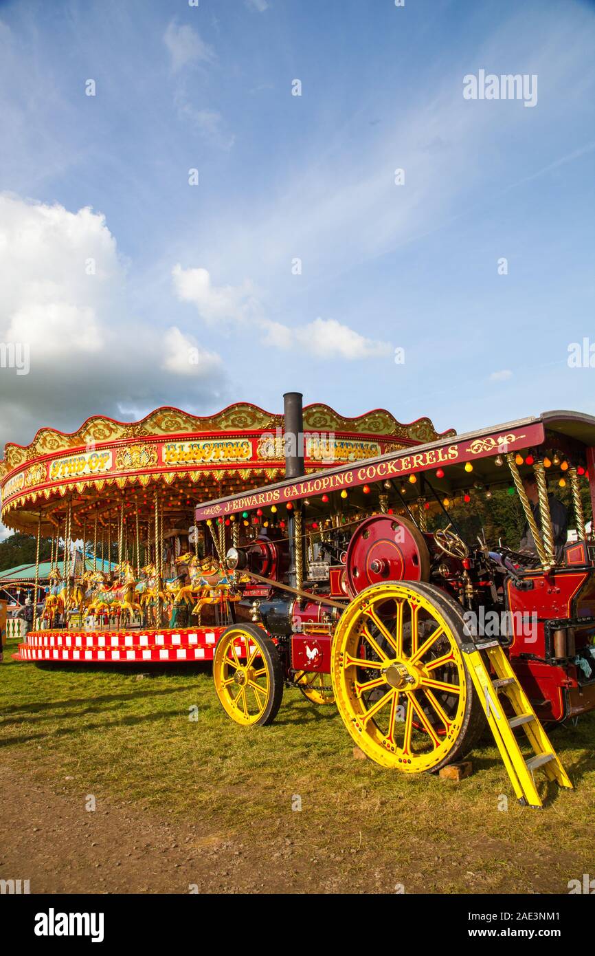 Steam driven vintage carousal with hobby horses being driven by a ...