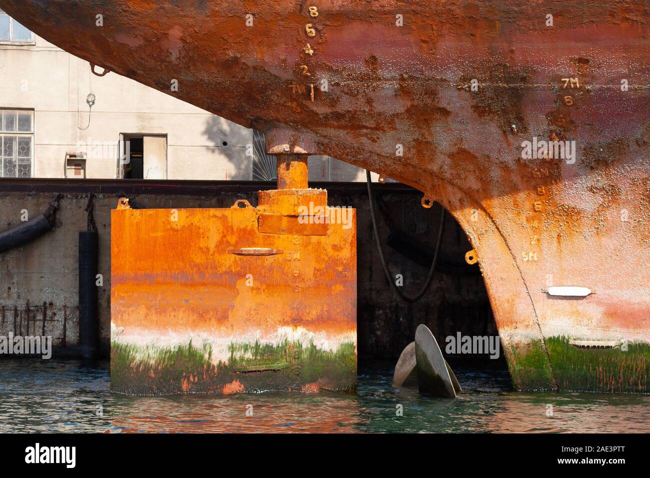 Stern ship, rudder and propeller. Iron rusty ship hull partially ...