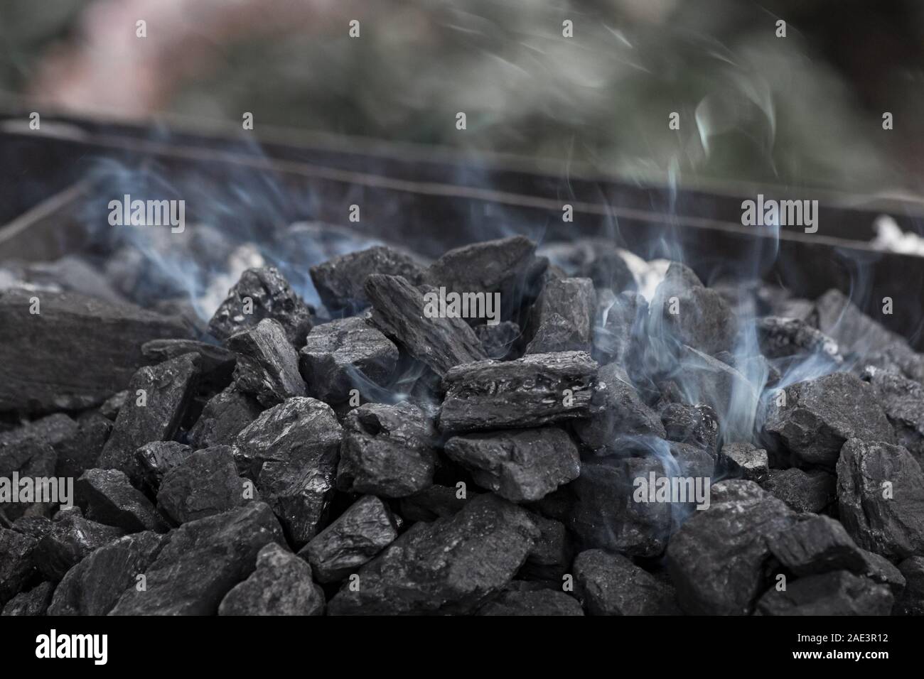 Smoke over the coals of a blacksmith's brazier Stock Photo - Alamy