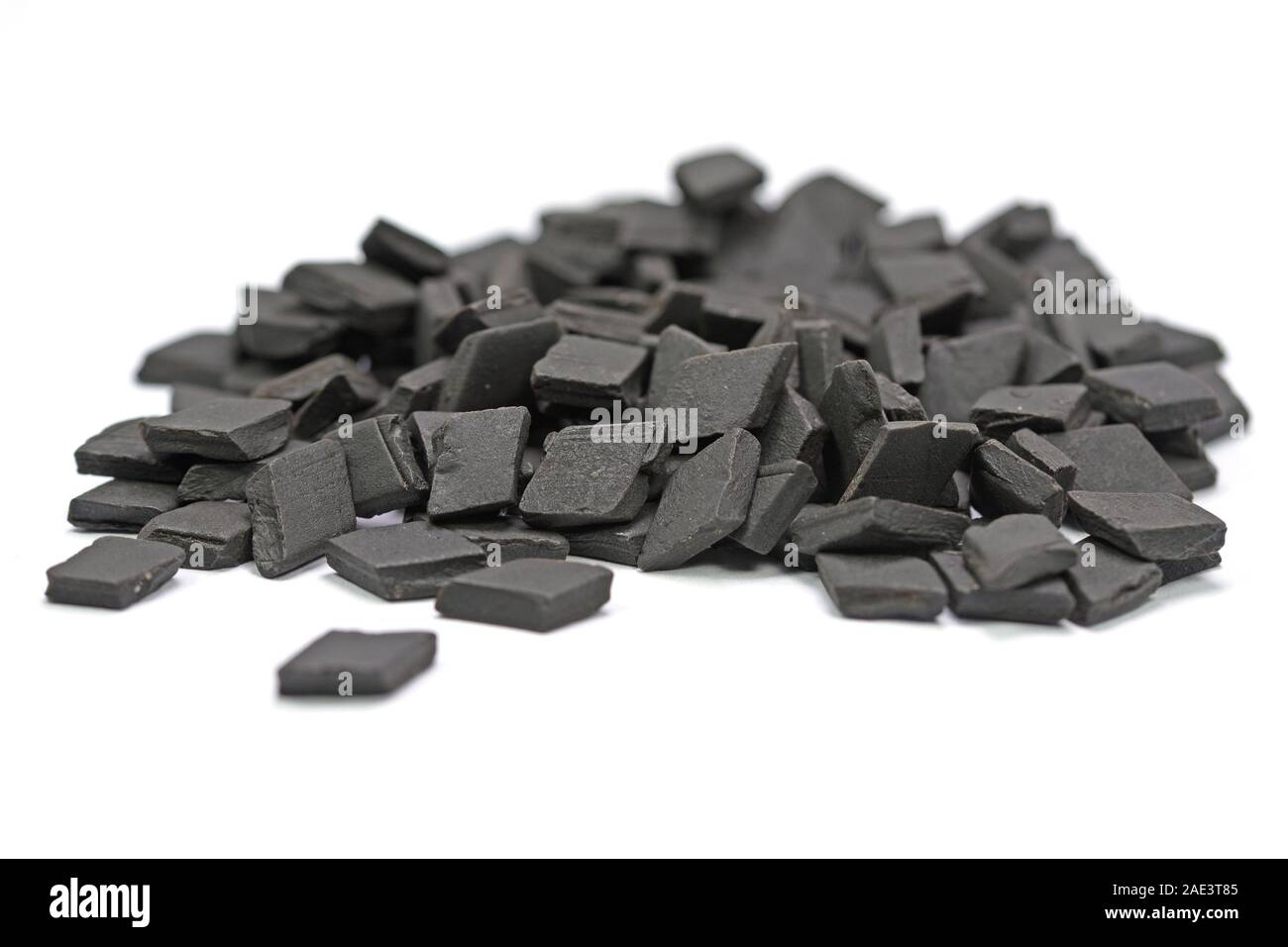 Salmiac pastilles in front of white background Stock Photo - Alamy