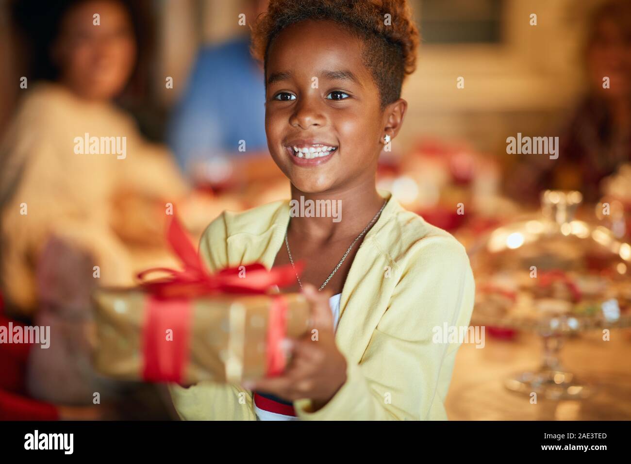 Happy child holding and giving a Xmas present, peace and happiness ...