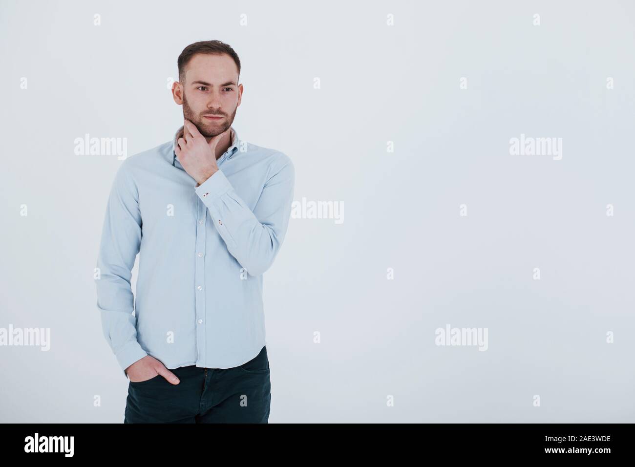 One person. Man in official clothes stands against white background in ...