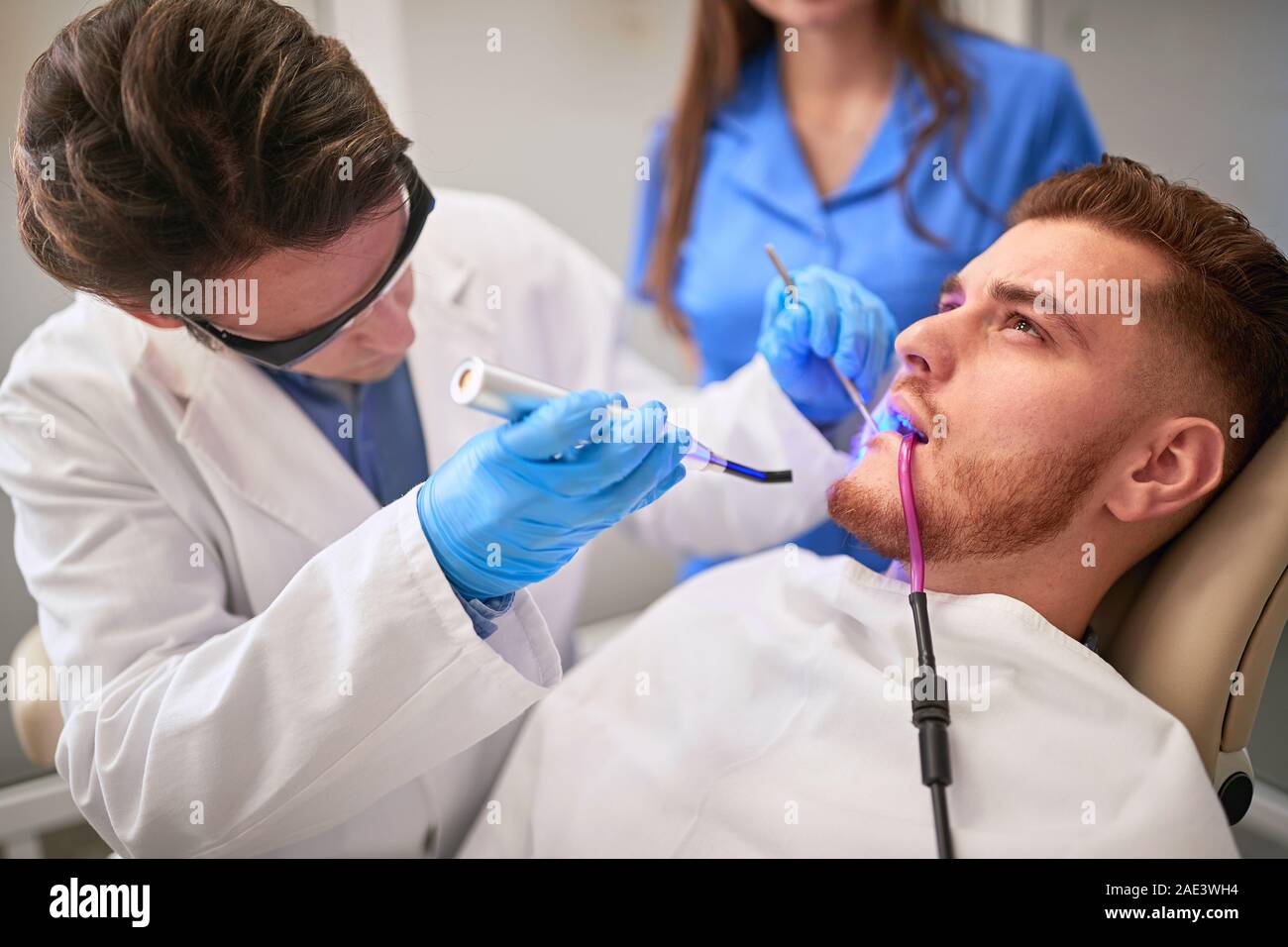Dentist at work with patient in dental clinic Stock Photo - Alamy