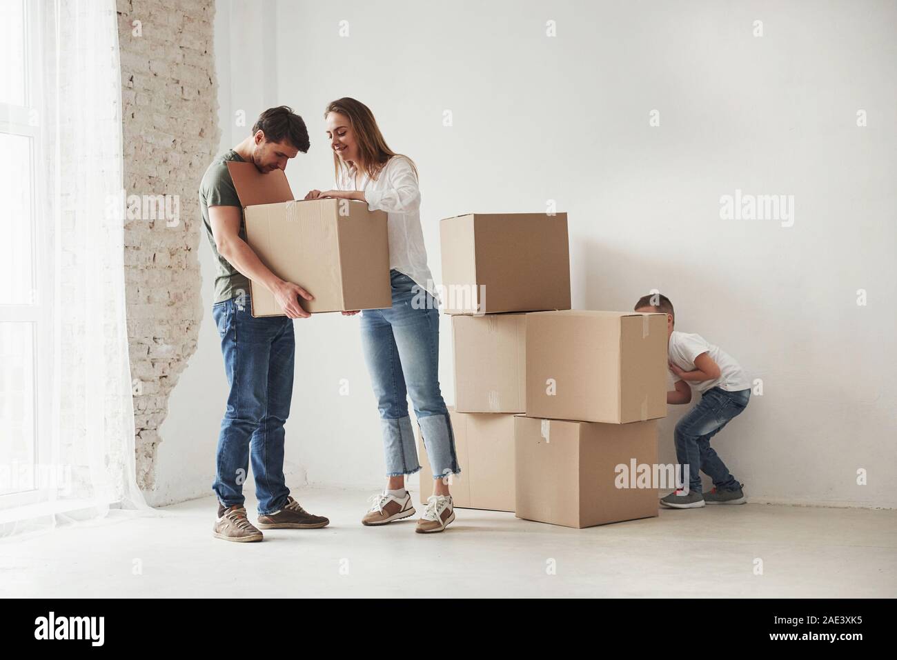 Hiding behind the boxes. Family have removal into new house Stock Photo ...