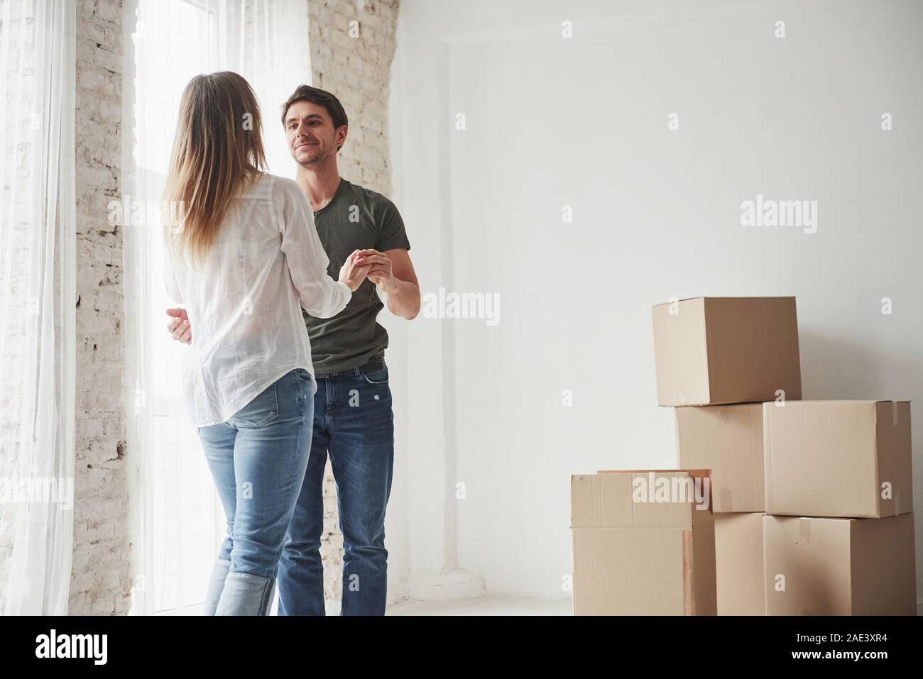 Adult dancers. Young couple celebrating their removal to the new house ...