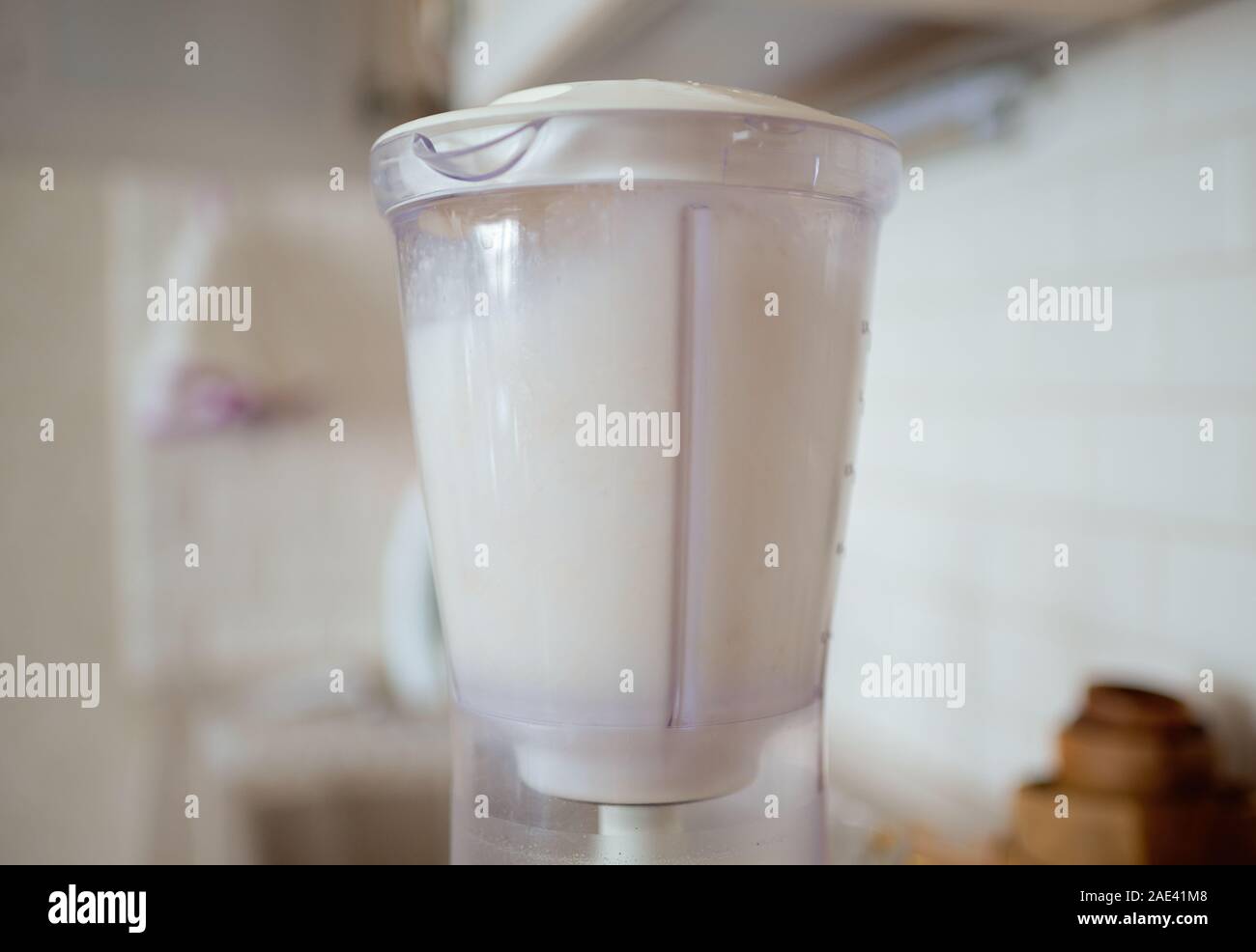 Blender and almonds soaked in water. Making healthy vegan milk Stock ...