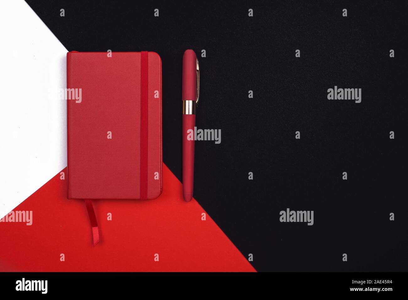 red Notepad with pen on red, white and black background. Top view. flat ...