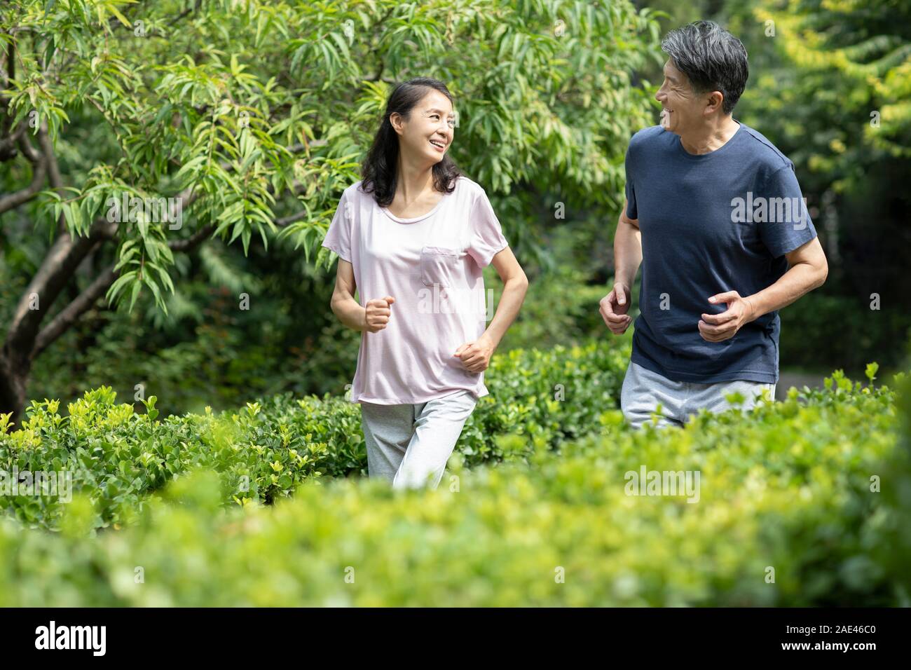 Happy mature chinese couple running hi-res stock photography and images - Alamy