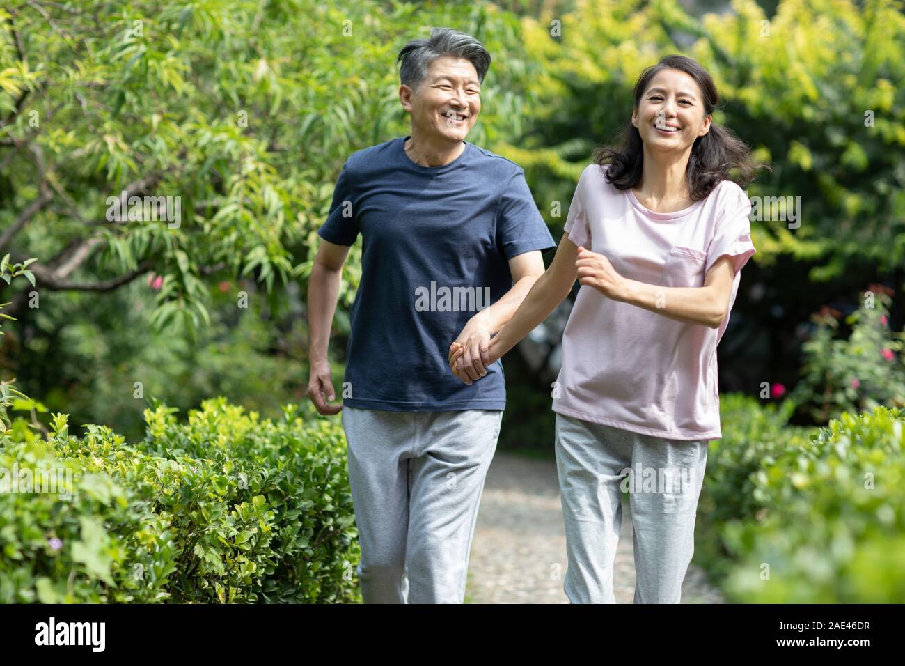 Happy mature chinese couple running hi-res stock photography and images ...