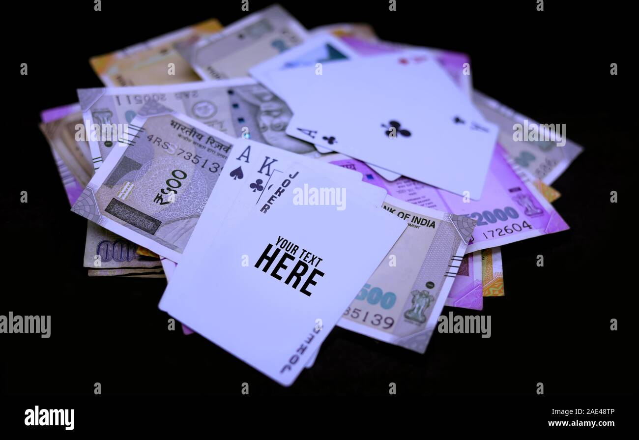playing poker, playing cards with Indian Rupee Banknotes on black ...
