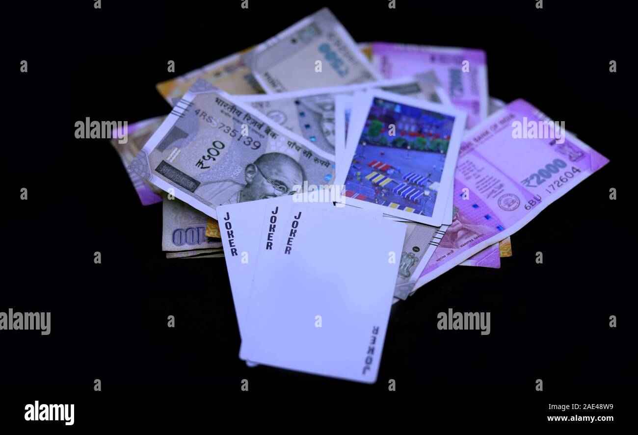 Playing Cards and Indian Currency Rupee bank notes on black backgrounds ...