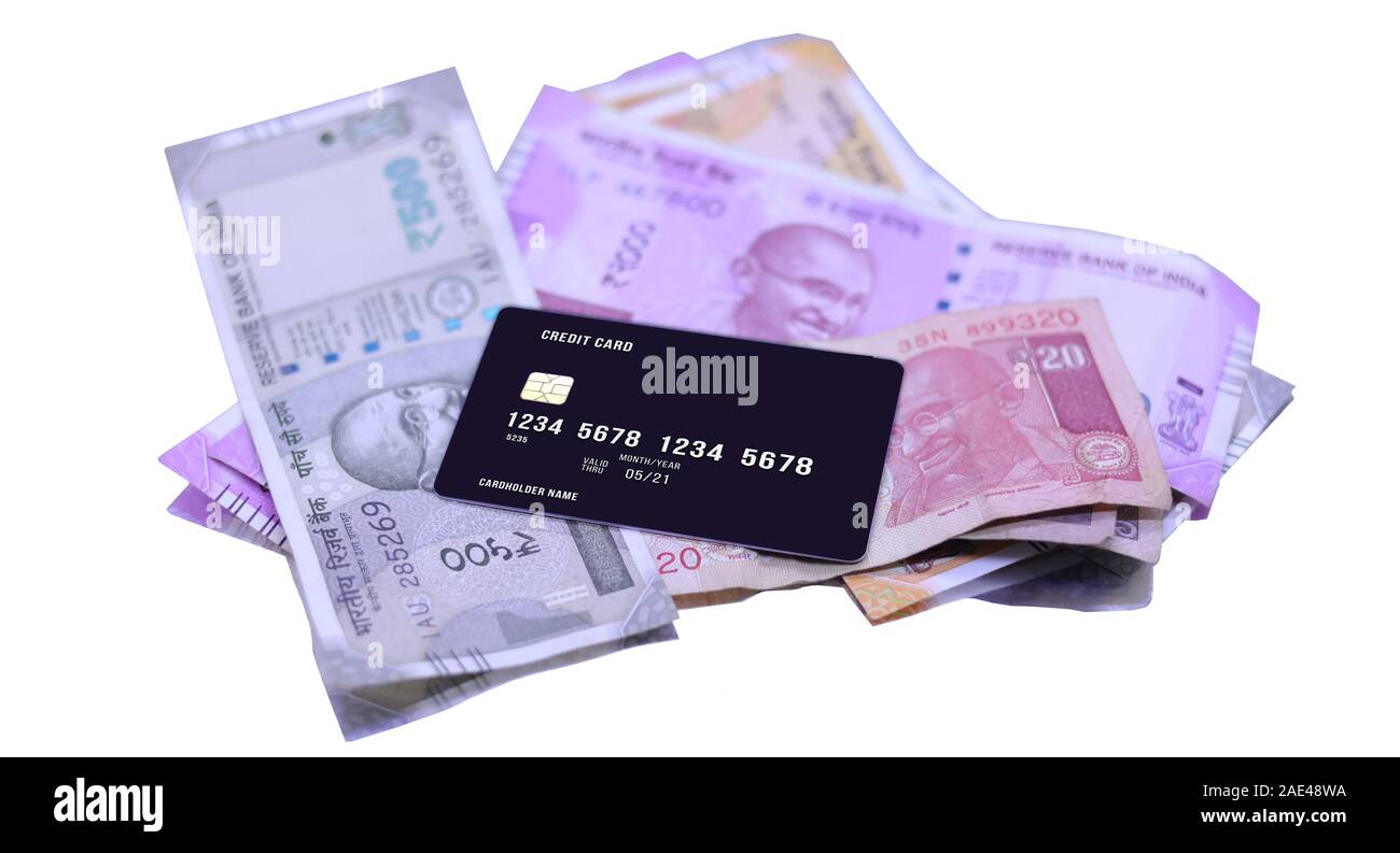 Indian currency note with credit and debit cards on the white ...