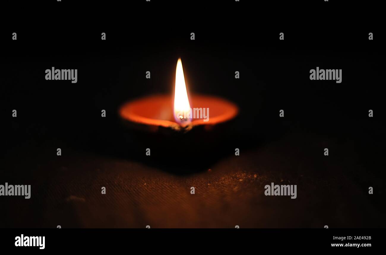 Diya lamp with fire. Traditional Divali festival. Closeup Stock Photo ...