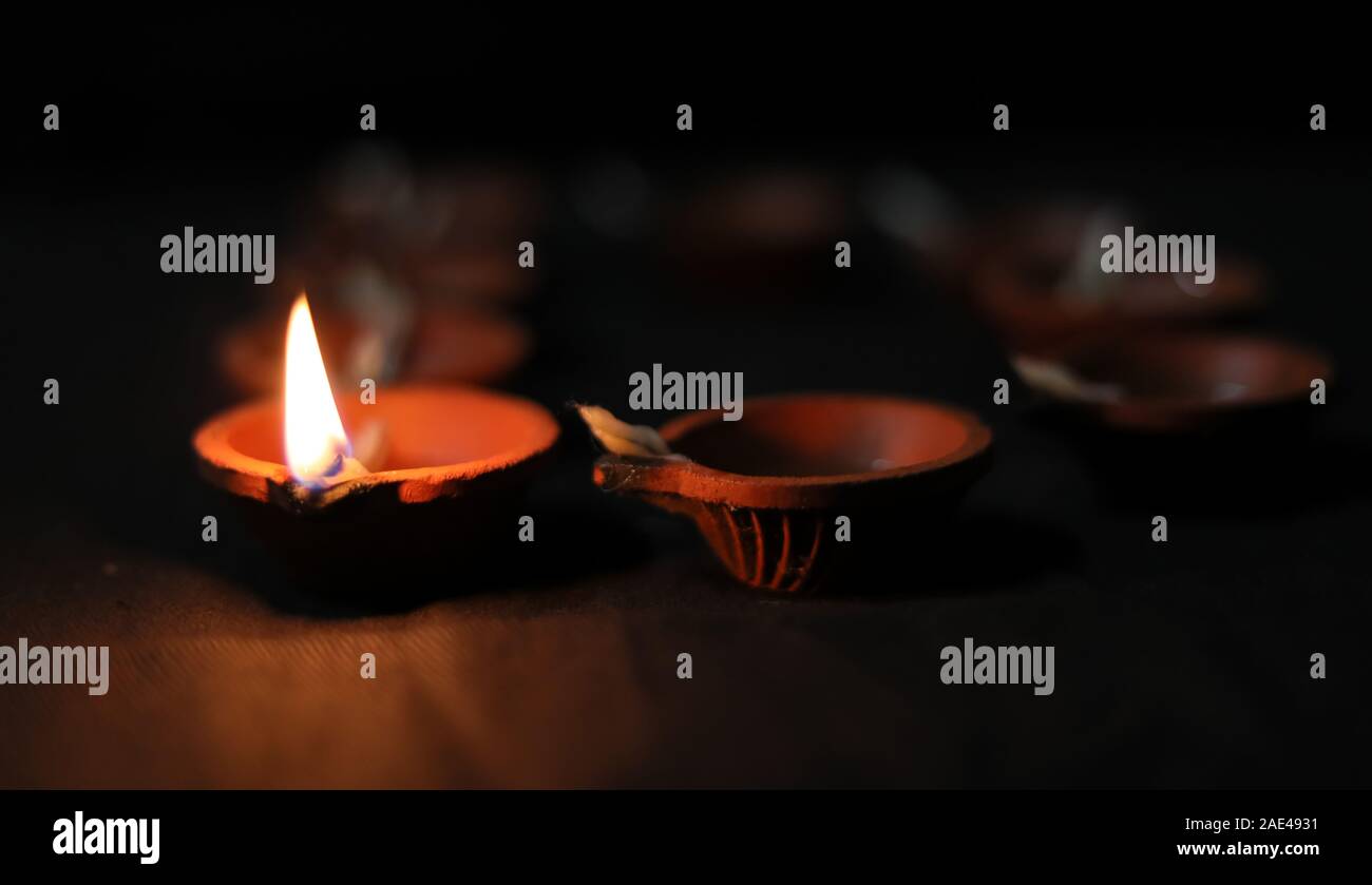 Happy Diwali - Lit diya lamps in the dark black backgrounds Stock Photo ...