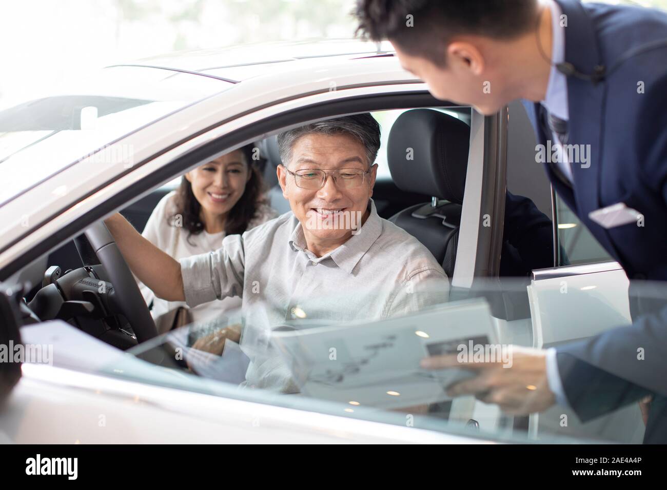 Happy mature couple taking a test drive Stock Photo - Alamy