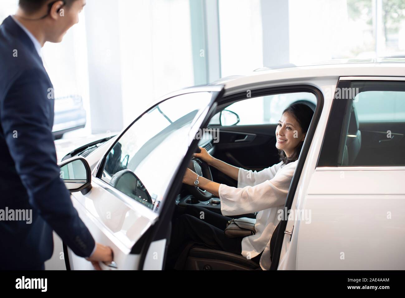 Happy mature woman taking a test drive Stock Photo - Alamy