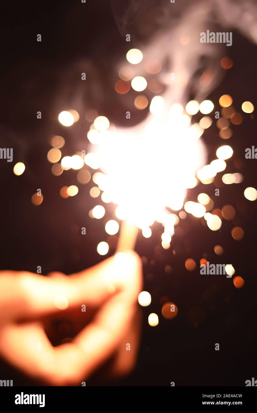 Hand Holding Burning Sparkler Blast On A Black Backgrounds Stock Photo ...
