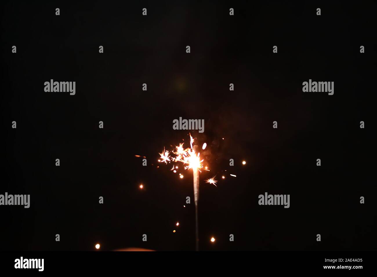 Hand holding burning sparkler blast on a black backgrounds Stock Photo ...