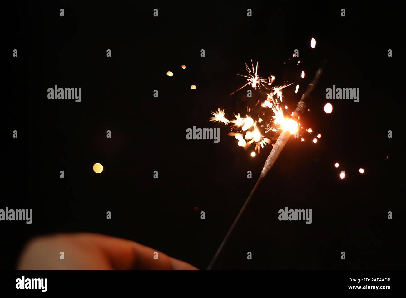 Hand Holding Burning Sparkler Blast On A Black Backgrounds Stock Photo ...