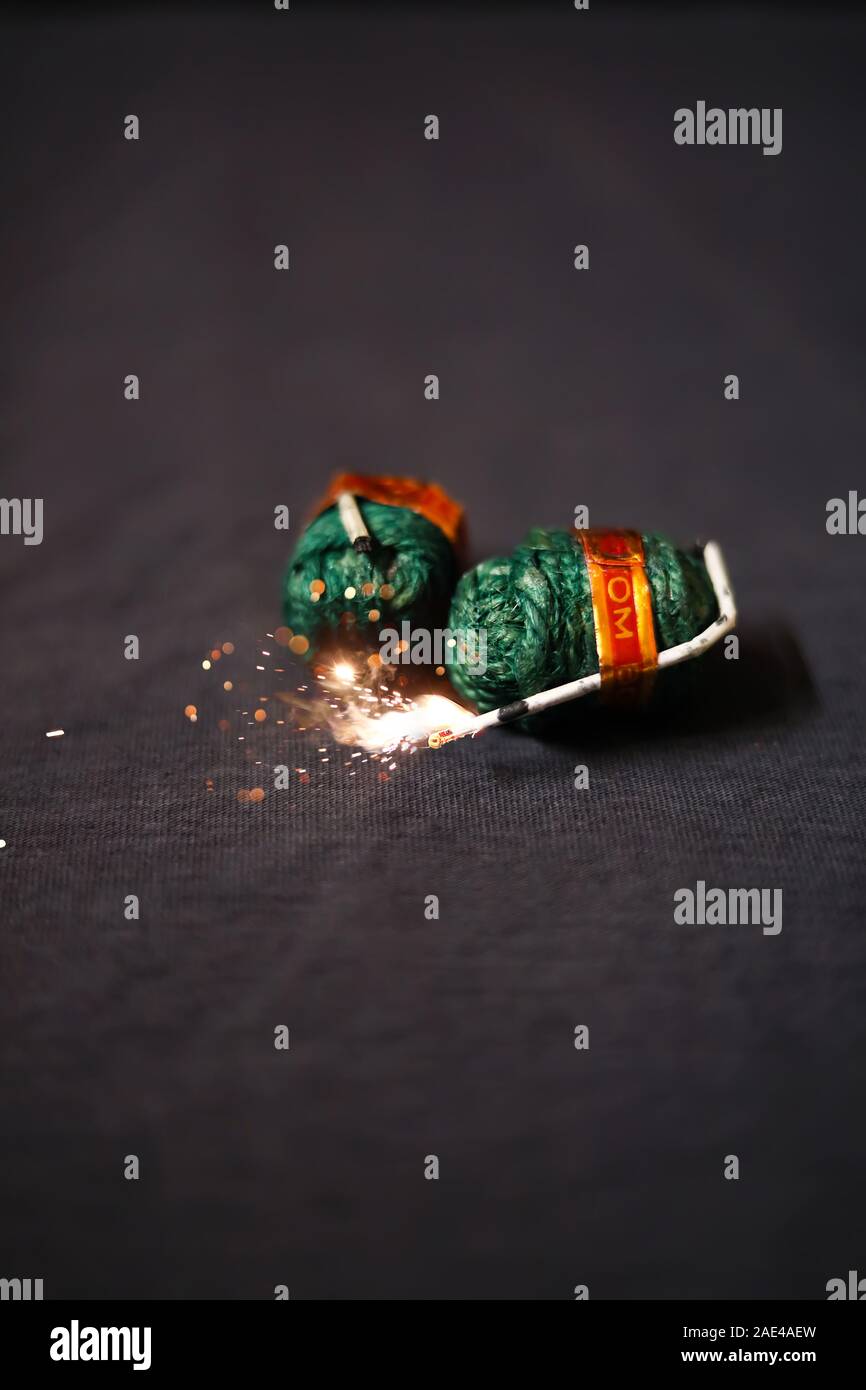 Diwali fire bomb cracker on black backgrounds Stock Photo - Alamy
