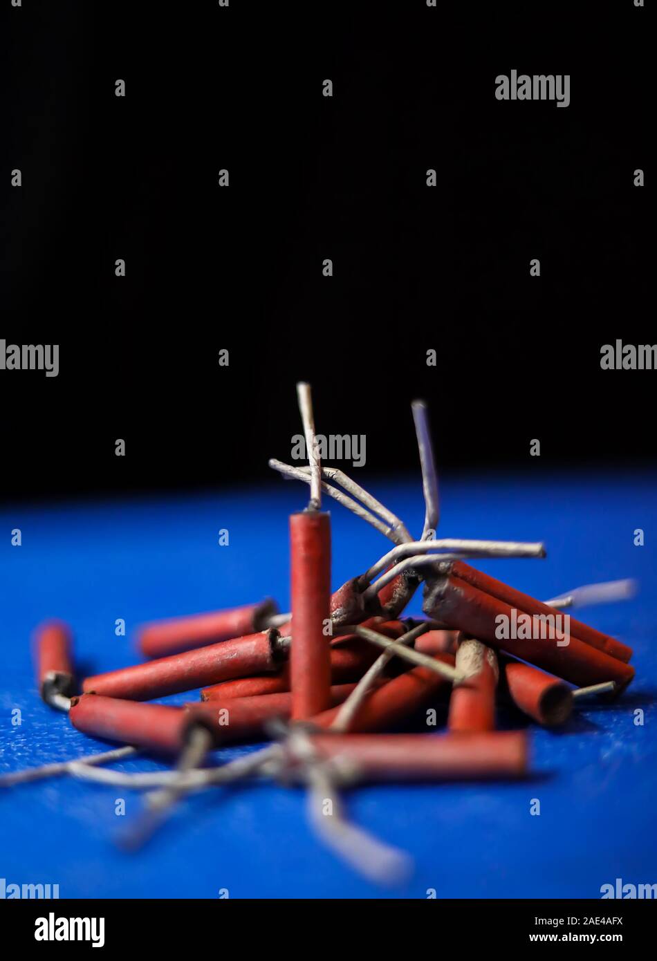 Stack of firecrackers for Diwali festival on blue and black backgrounds ...