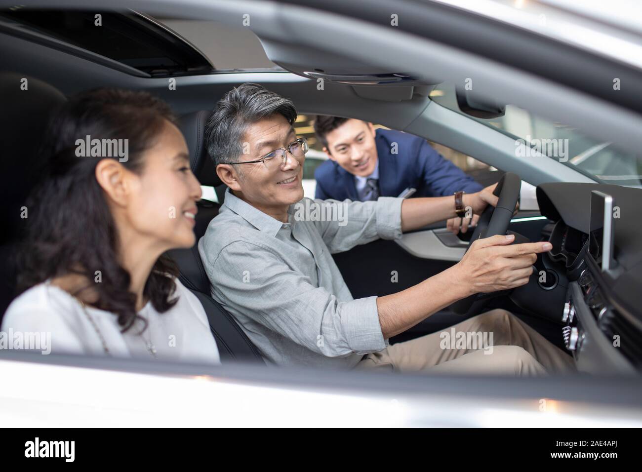 Asian couple driving new hi-res stock photography and images - Alamy