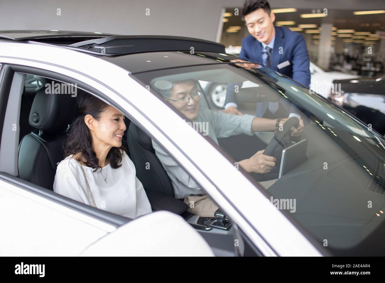 Happy mature couple taking a test drive Stock Photo - Alamy