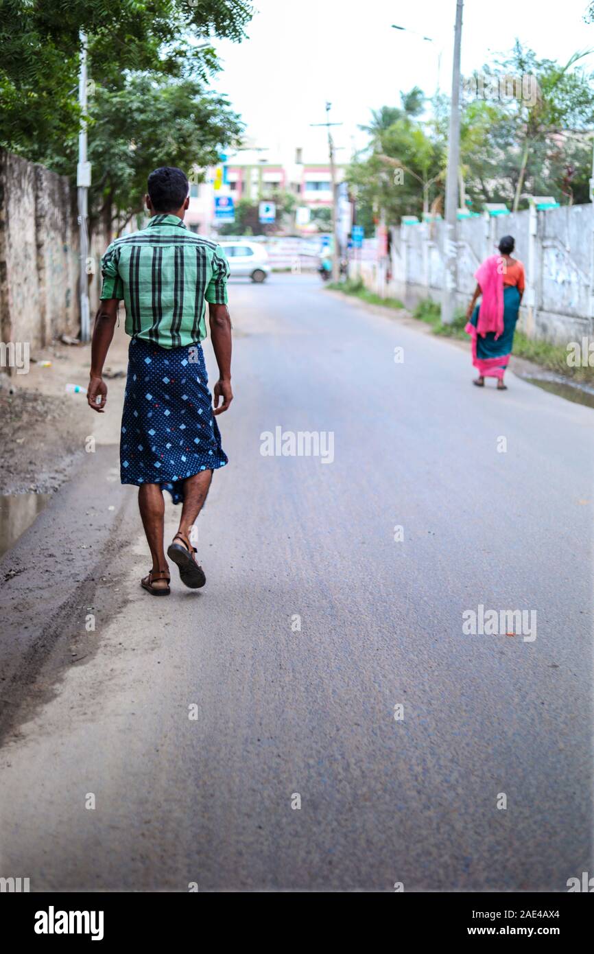Back view Indian young man walking on streets Stock Photo - Alamy