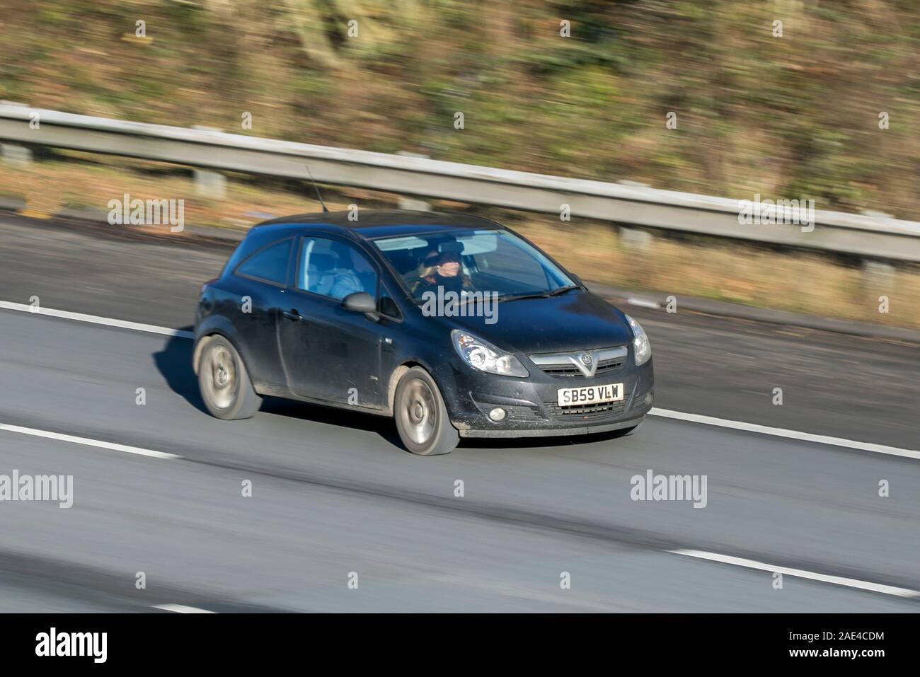 Blurred moving car Vauxhall Corsa Sri traveling at speed on the M61 ...