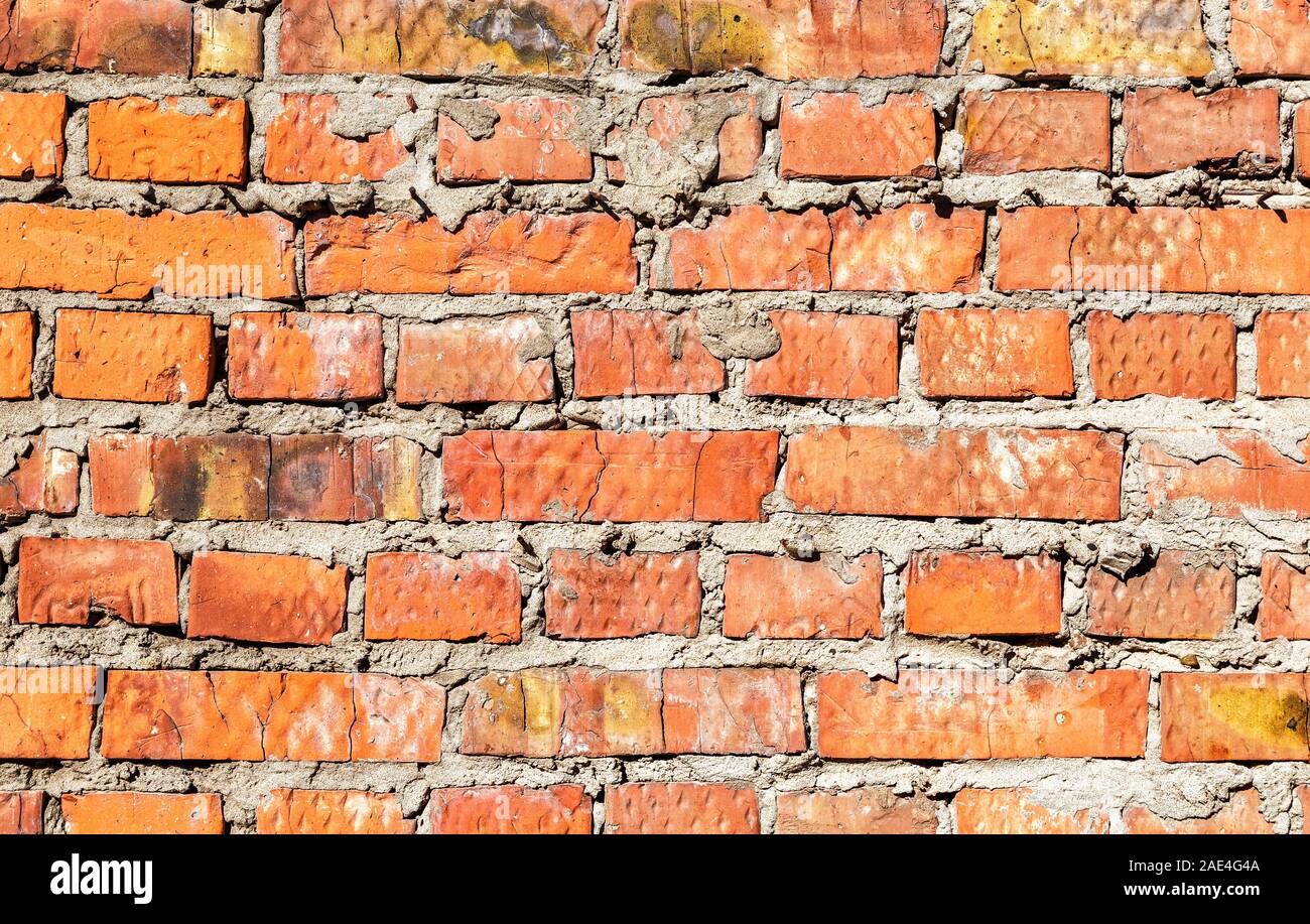 Rough red brick wall as background texture. Bricks masonry with uneven ...
