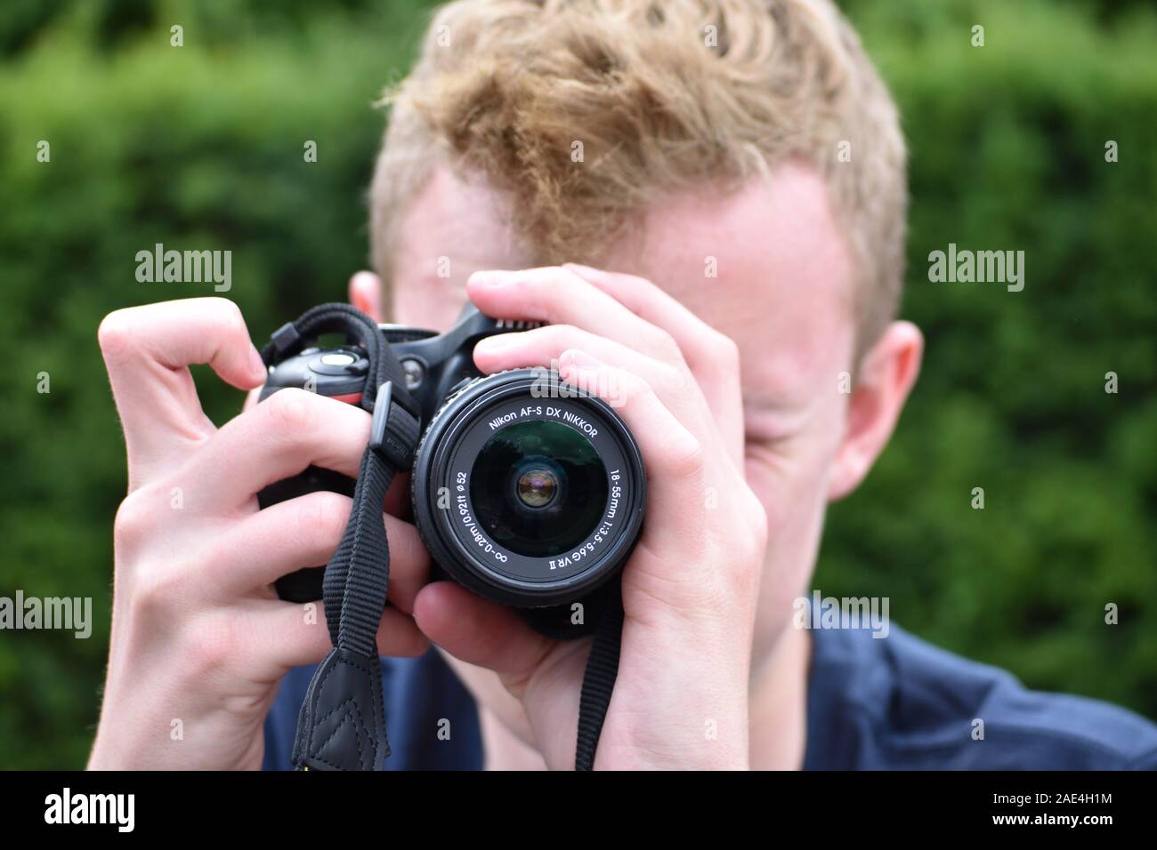 Picture of a boy using a camera Stock Photo - Alamy