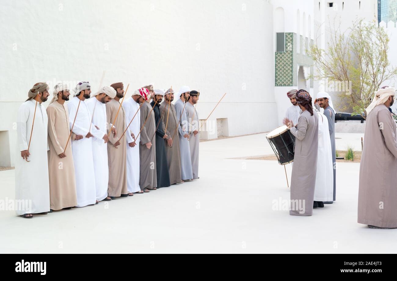 Emirati Men performing the Yowla, a traditional dance in the heritage ...