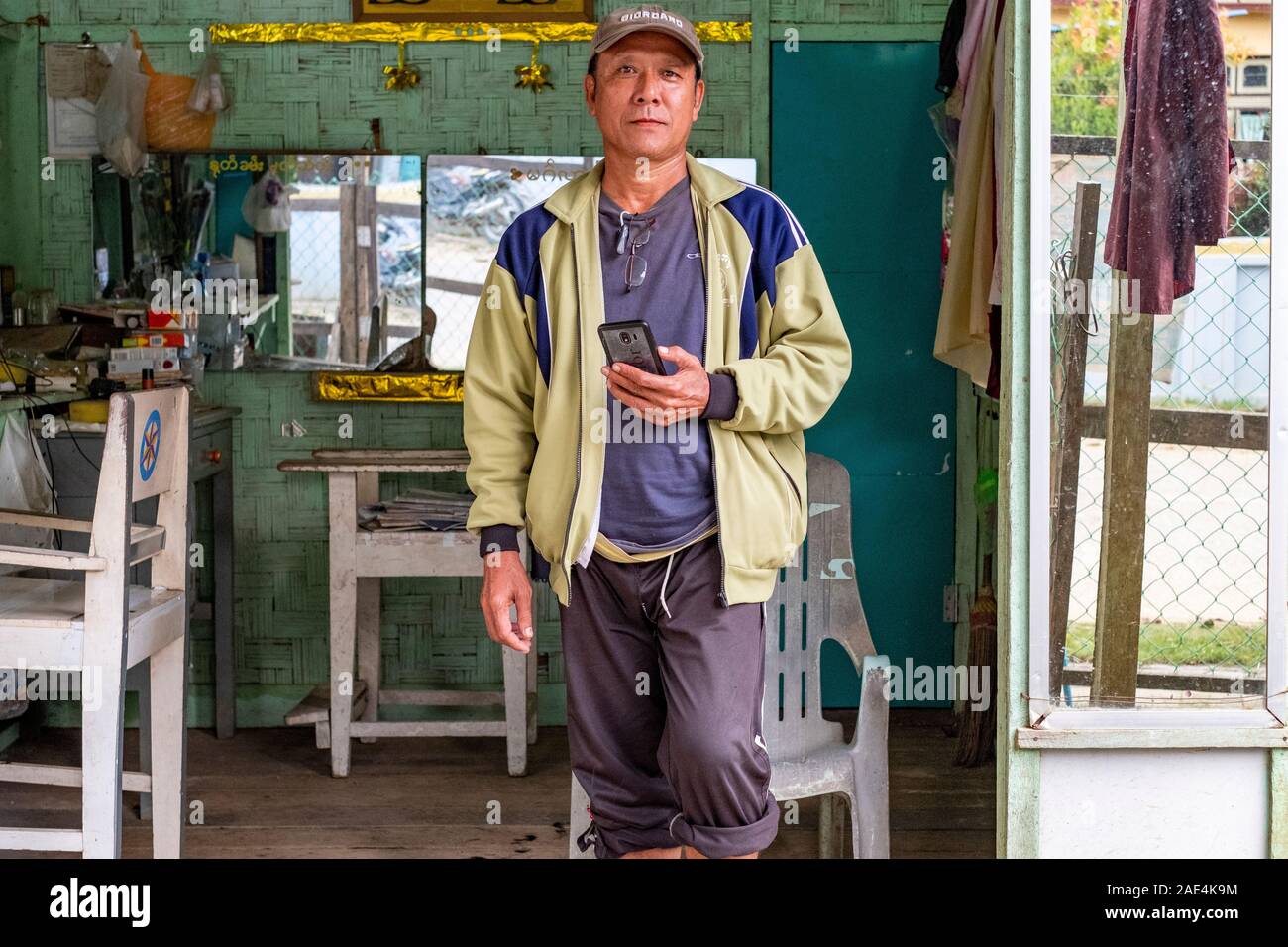 Simple open-air barber shop with barber waiting for customers while ...