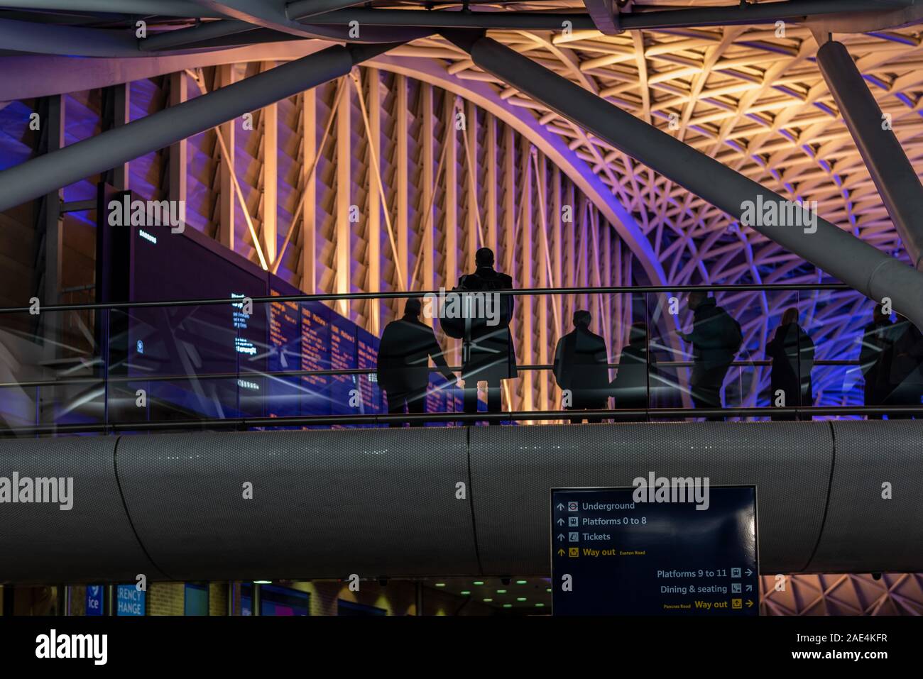 Kings Cross Station London - Commuters look at departure boards in the ...