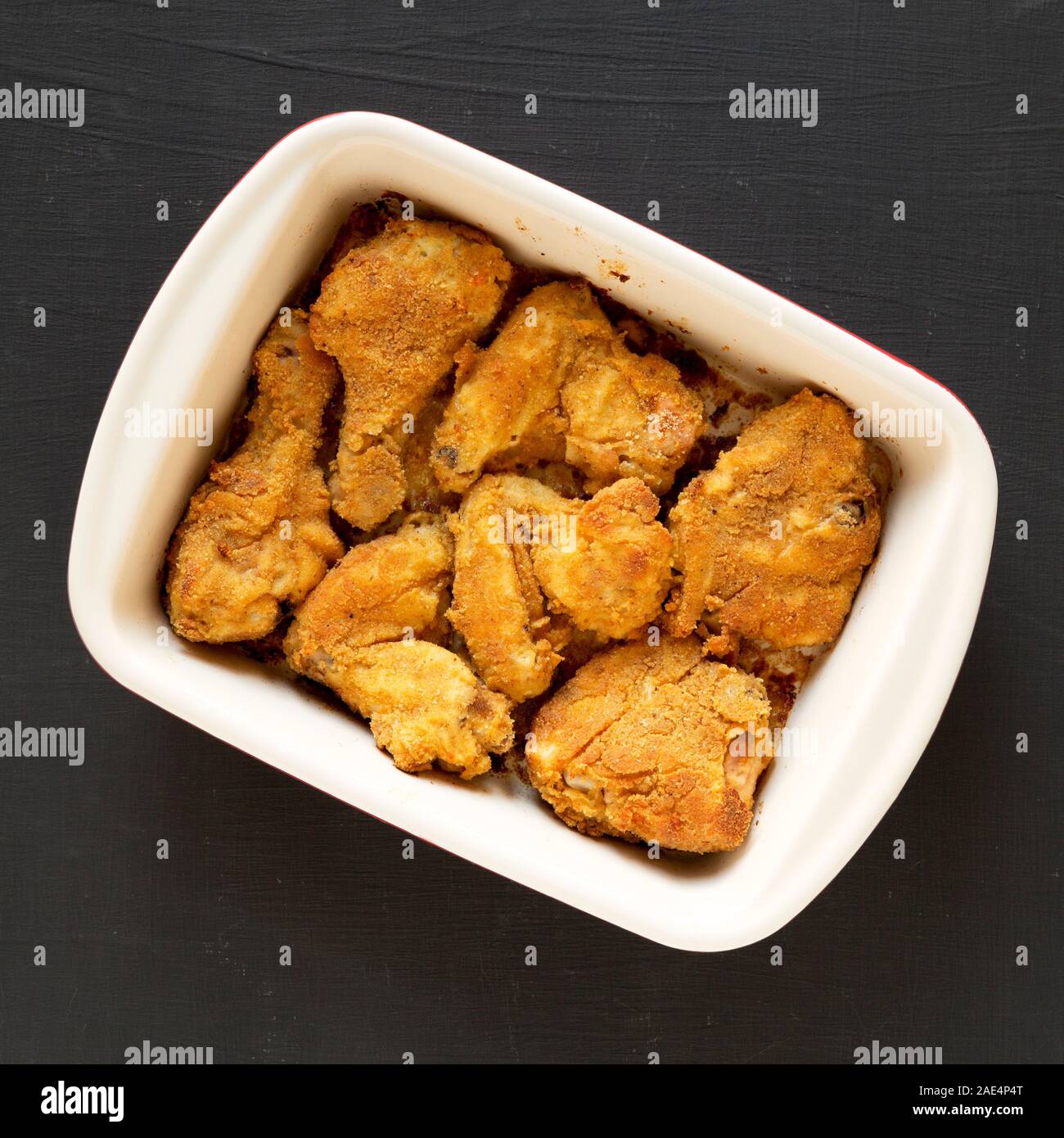 Delicious homemade oven baked fried chicken in a dish, top view. Flat ...