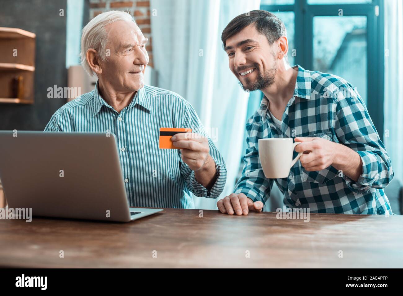 Joyful young man holding hi-res stock photography and images - Alamy
