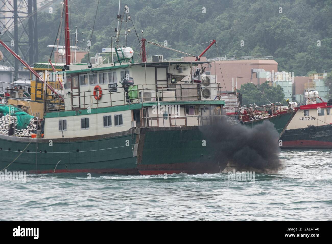 Heavy, black smoke and exhaust spews from Industrial fishing boats and ...
