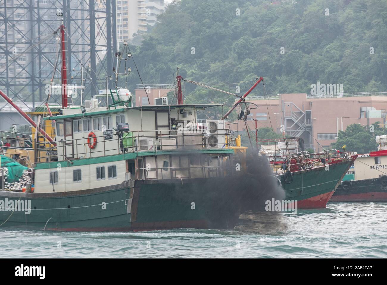 Heavy, black smoke and exhaust spews from Industrial fishing boats and ...
