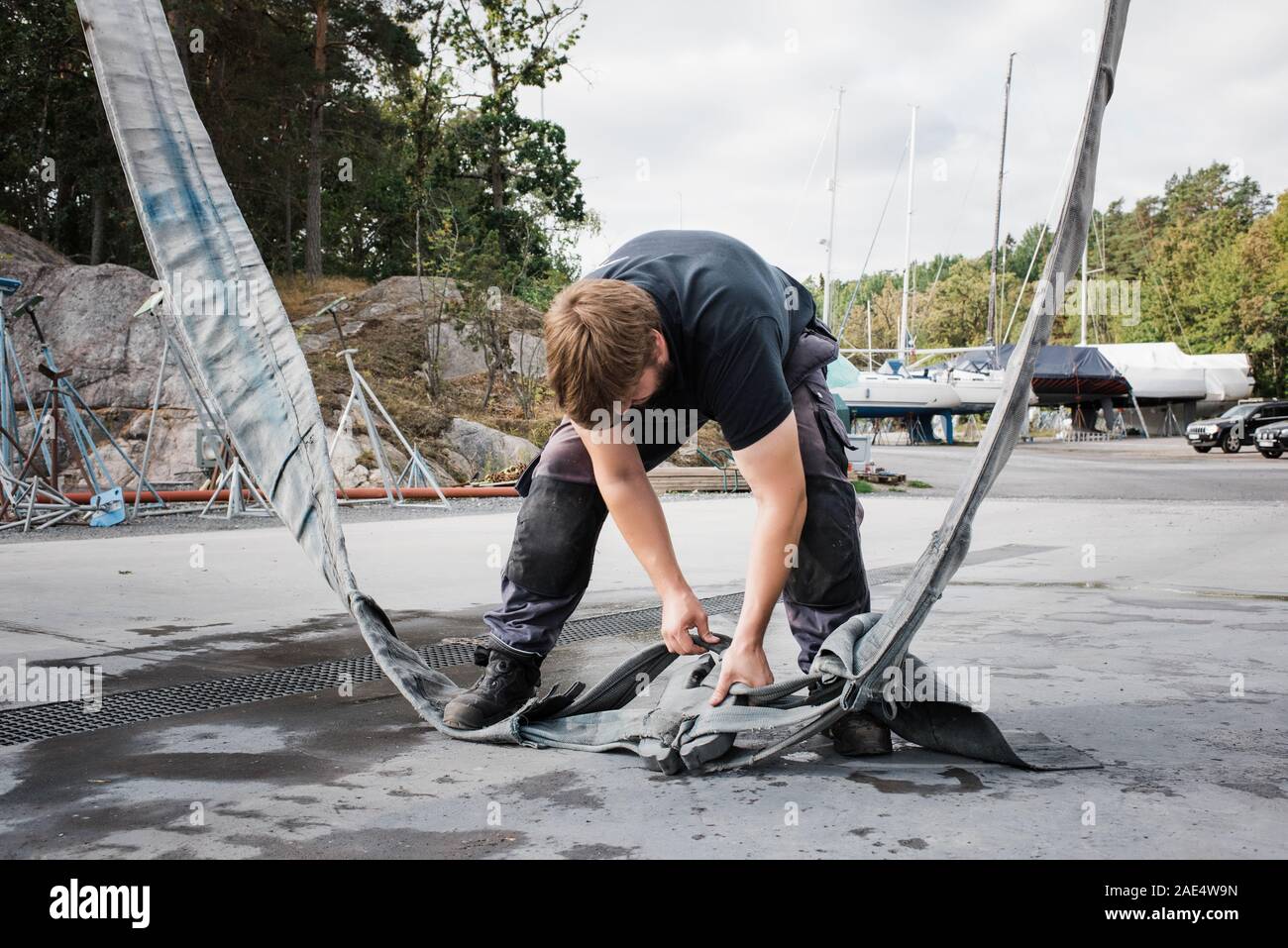 Marine engineer technician moving yachts in a marina outside Stock ...