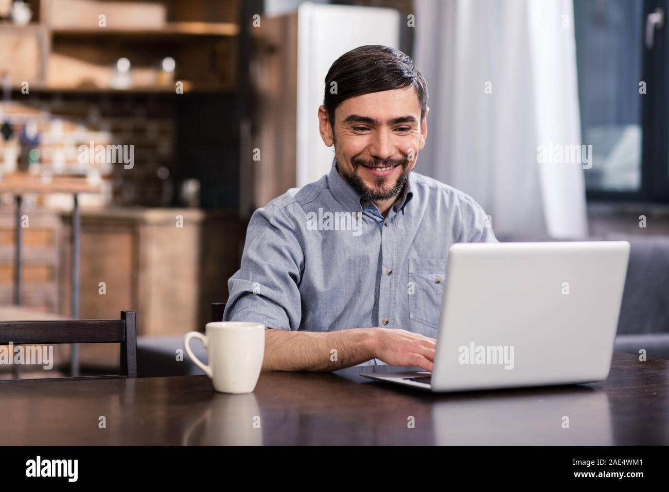 Young man sitting table typing hi-res stock photography and images - Alamy