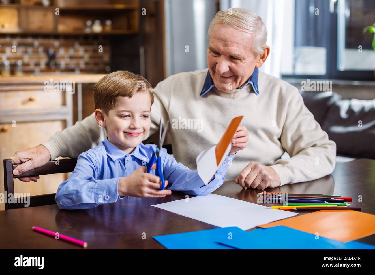 Positive little boy making a festive card Stock Photo - Alamy